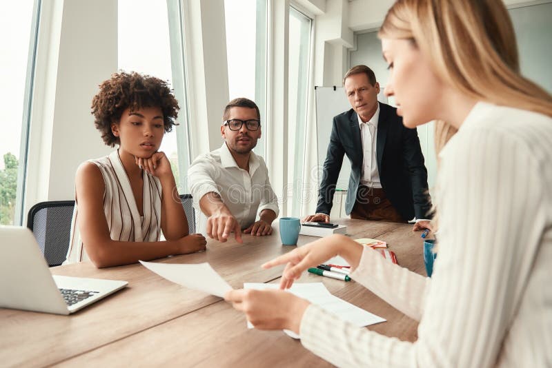 Business Meeting. Group of Young Business People Looking at Documents ...