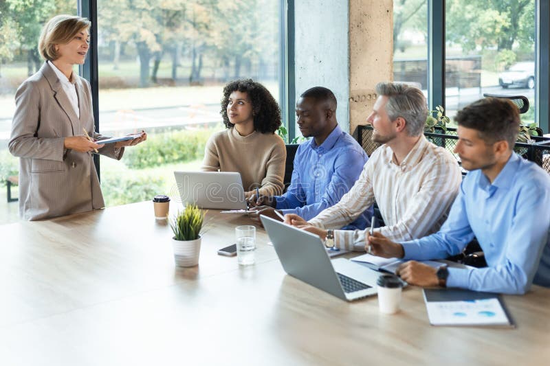 Business Meeting - Manager Discussing Work with Her Colleagues. Stock ...