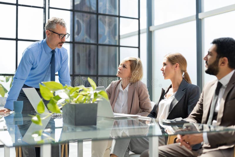 Business Meeting - Manager Discussing Work with His Colleagues. Stock ...
