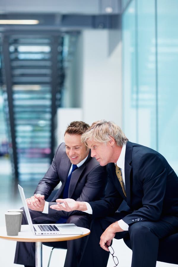 Business Men Conversing while Looking at Laptop. Portrait of Handsome ...