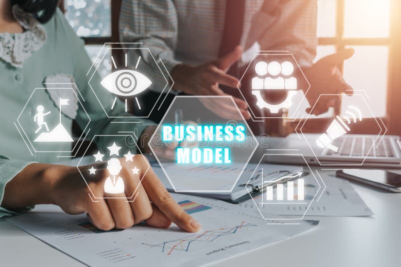 Two Business Colleagues Discussing Data on Desk with Business Model ...