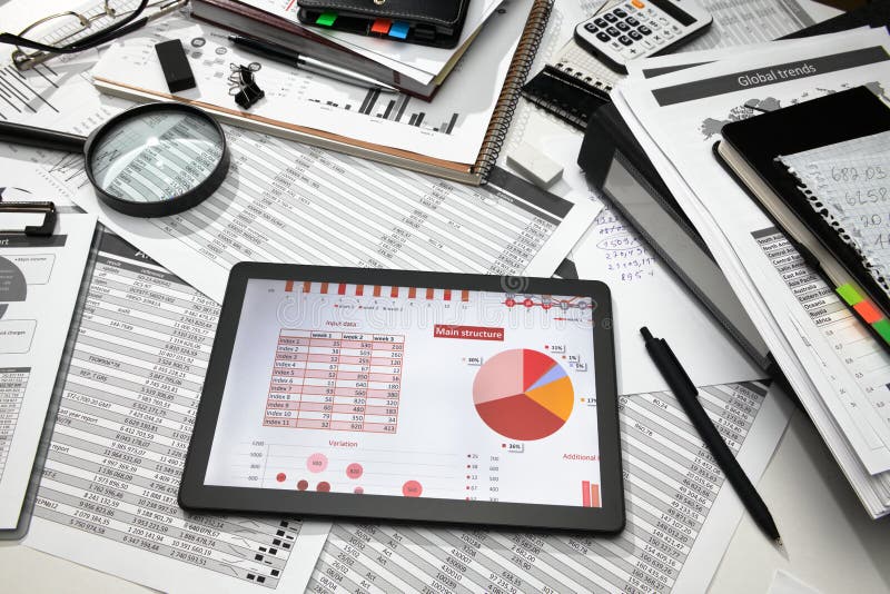 Business Office Desk Closeup - Tablet Computer with Tables and Graphs ...
