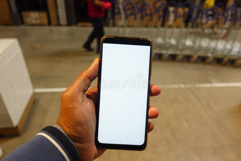 Business Owner Holding Phone Mock Up in Warehouse. Stock Photo - Image ...