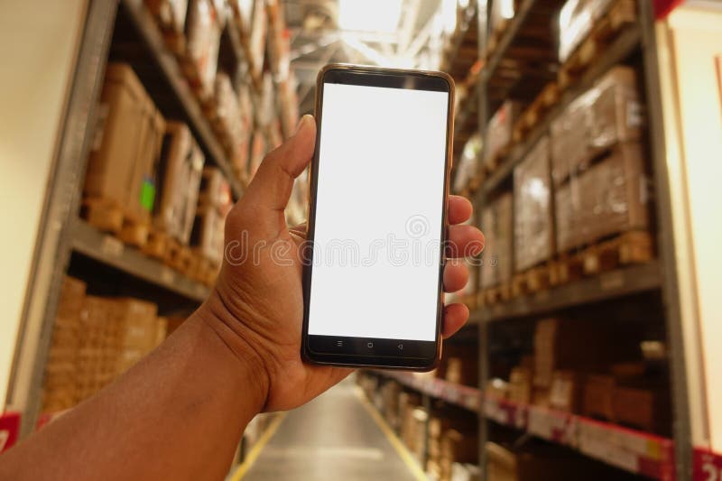 Business Owner Holding Phone Mock Up in Warehouse. Stock Photo - Image ...