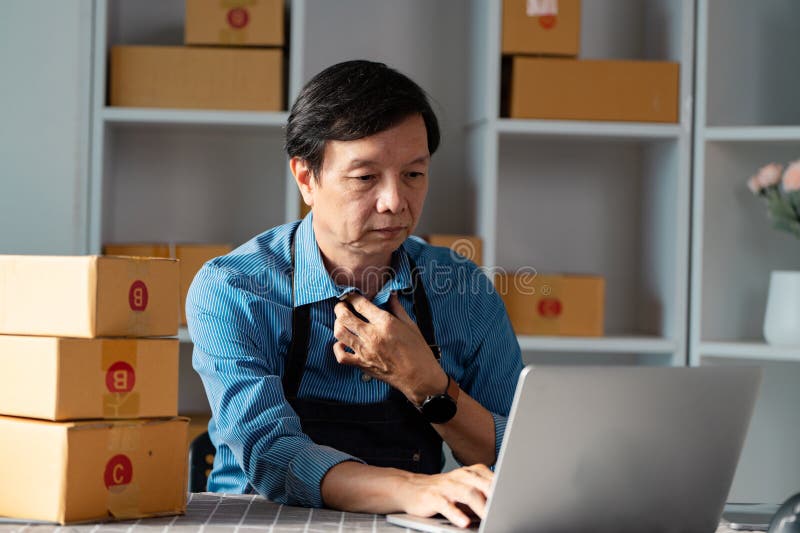 Business Owner Managing Inventory and Orders Using a Laptop in a ...