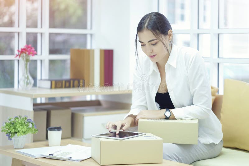 Business Owner Using Tabtet Computer Confirm and Check Packing List ...