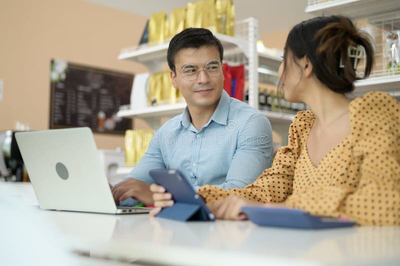 Business Owners are Analyzing Business Data , Talking and Smiling in ...