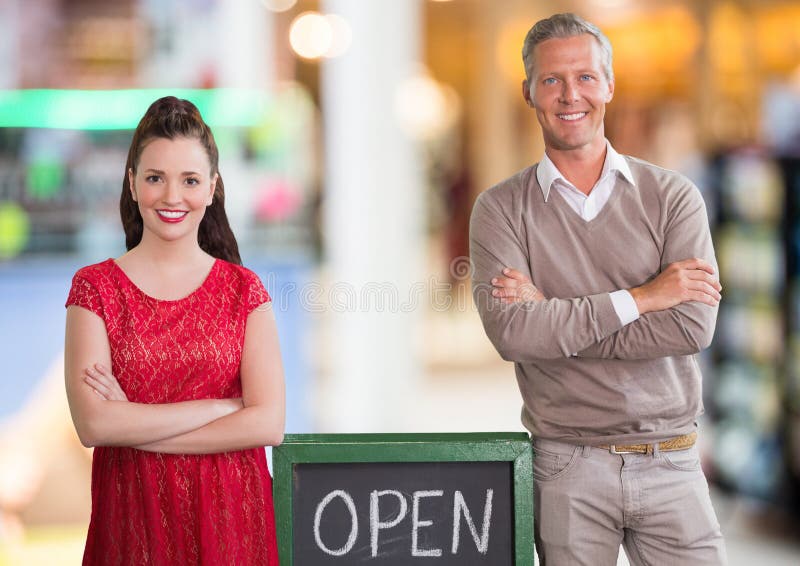 Business Owners with Open Sign and Arms Folded Against Blurry ...