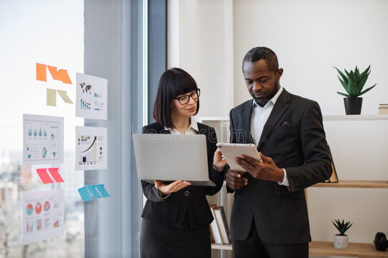 Business Partners Developing Plan in Office Using Computer Stock Photo ...