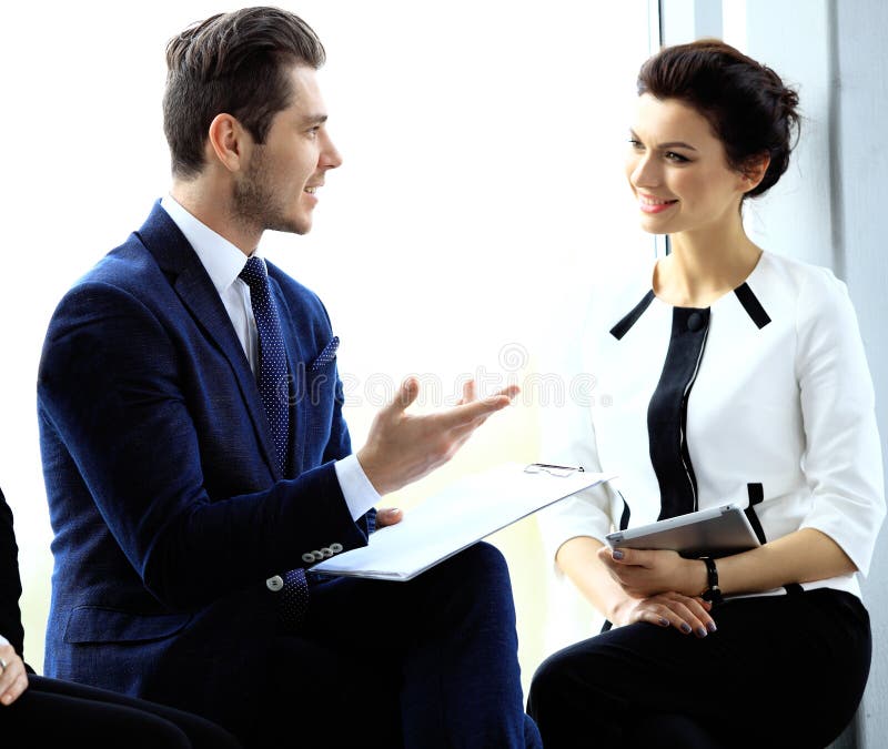 Business Partners Discussing Documents and Ideas at Meeting Stock Photo ...