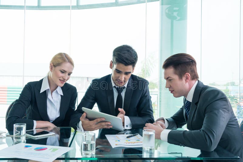 Business Partners Discussing Documents and Ideas at Meeting Stock Photo ...