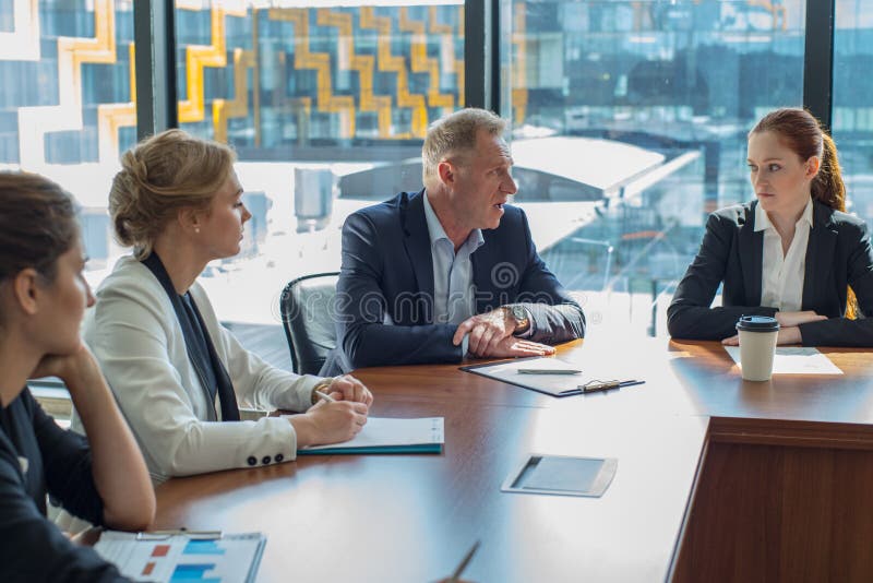 Business Partners Discussing Documents Stock Photo - Image of male ...