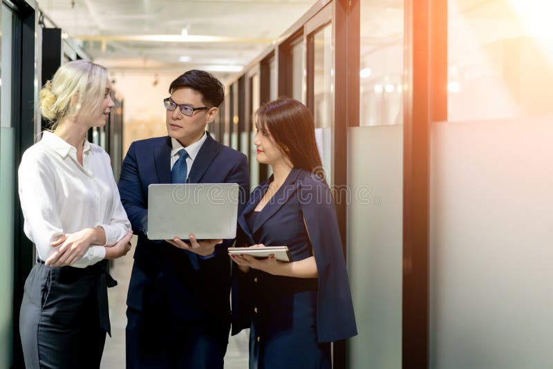 Business Partners Discussing Together Documents and Ideas at Office ...