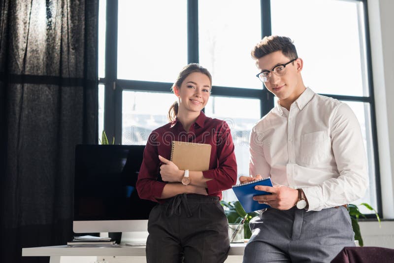 Business Partners Leaning Back on Work Desk and Looking Stock Photo ...