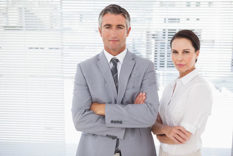 Business Partners Looking at Camera Stock Photo - Image of folded ...