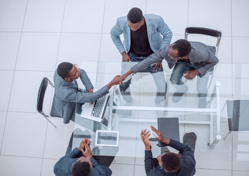 Business Partners Shaking Hands during Negotiations in the Office ...