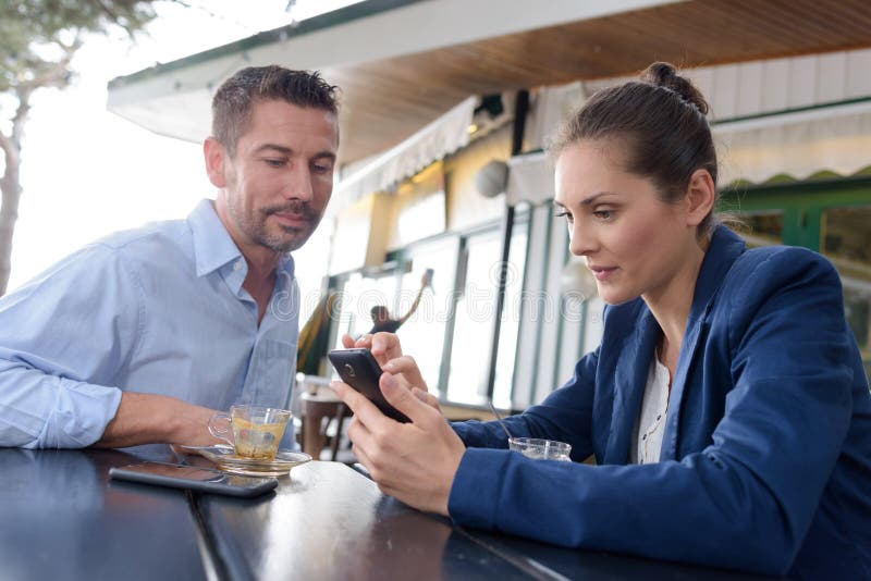 Business Partners Using Touch Screen Smartphone in Restaurant Stock ...