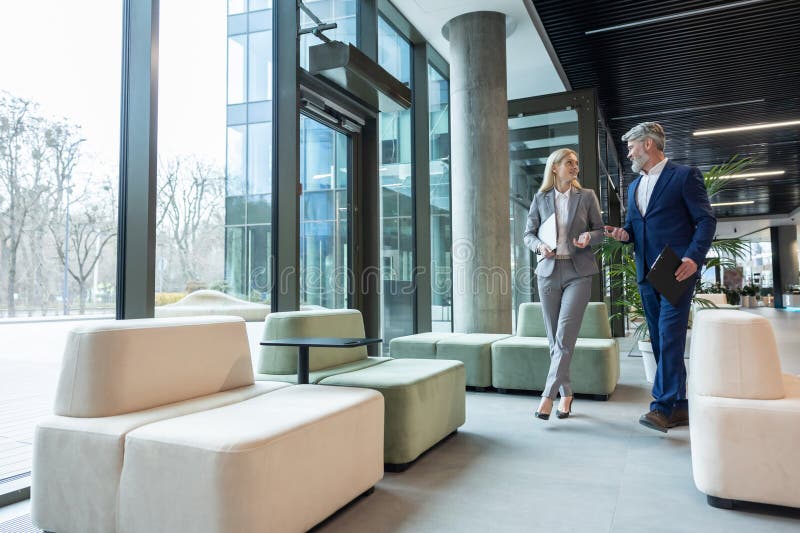 Business Partners Walking Center Hall Talking Stock Photos - Free ...