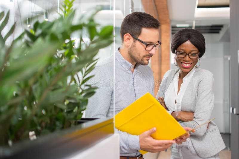 Business People Analyzing Document Together in Office Hall Stock Image ...
