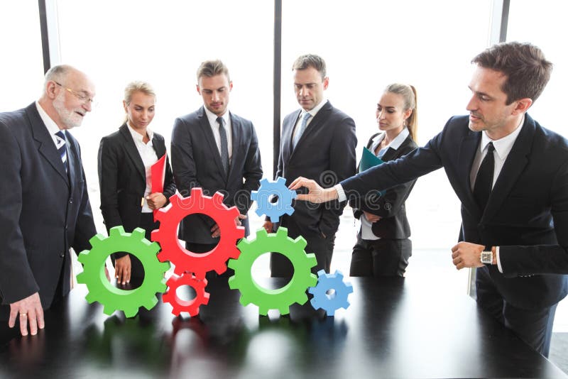 Business People Assembling Cogwheels Stock Photo - Image of people ...