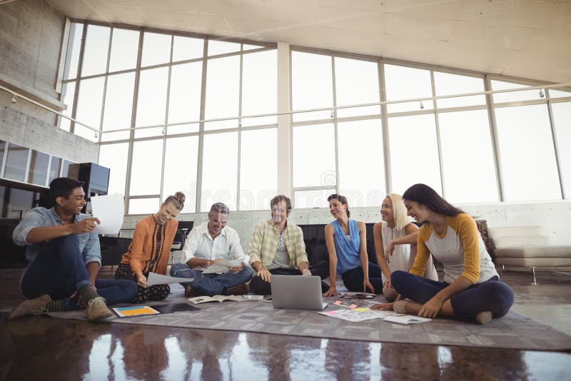 Business People with Charts and Laptop Planning in Creative Office ...