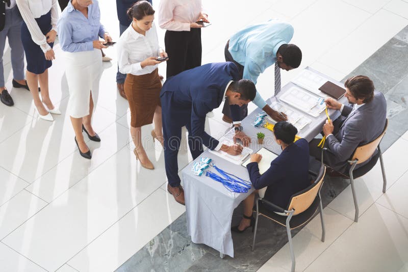 Business People Checking in at Conference Registration Table Stock ...