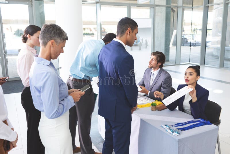 Business People Checking in at Conference Registration Table Stock ...