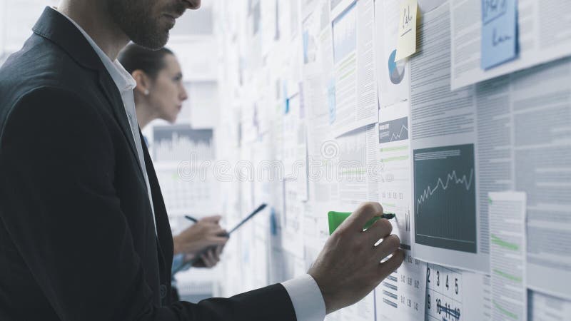 Business People Checking Financial Reports on a Wall Stock Photo ...