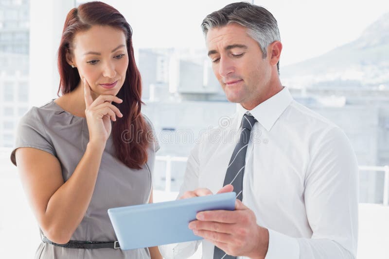 Colleagues Comparing a Blueprint Stock Photo - Image of happy, laptop ...