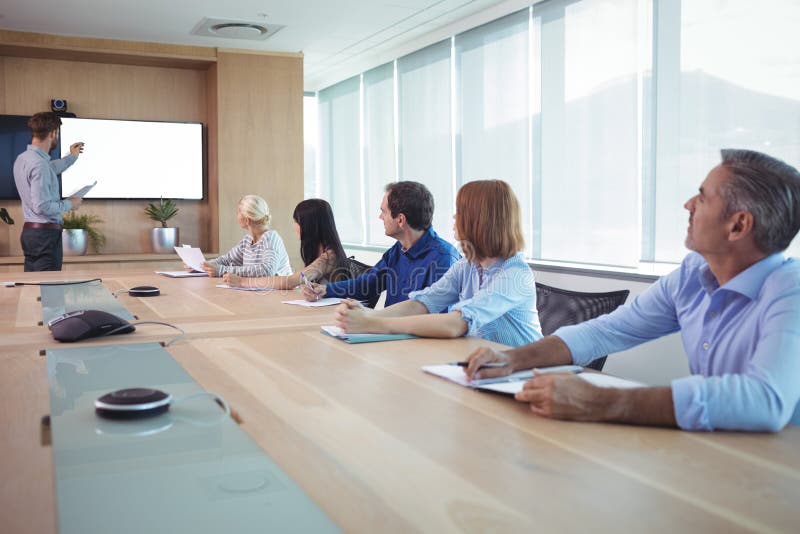 Business People at Conference Table during Meeting Stock Photo - Image ...