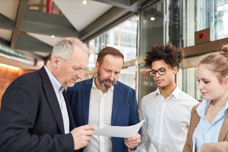 Business People from Consulting Team Read Business Plan Stock Photo ...