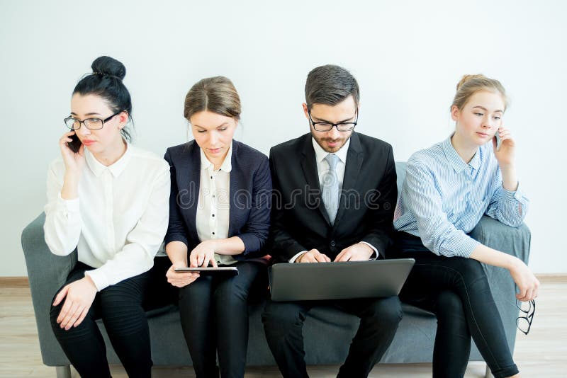 Business people on couch stock photo. Image of looking - 89759802