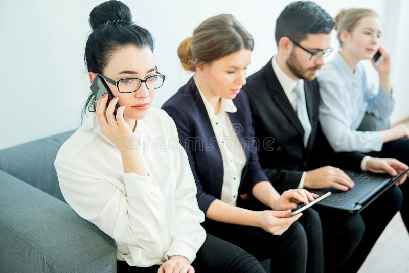 Business people on couch stock image. Image of office - 89759849