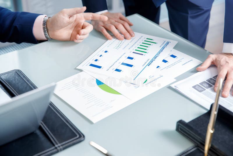 Business People Discuss Financial Statements. Stock Photo - Image of ...