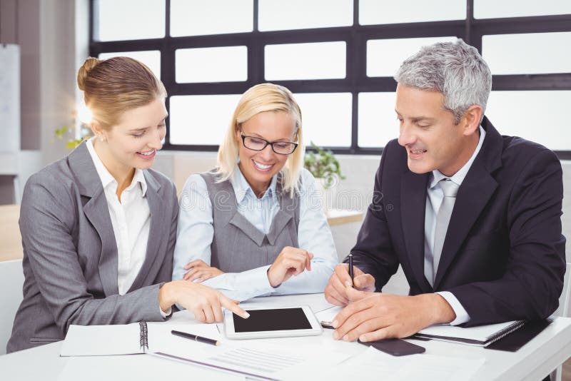 Business People Discussing with Client Over Digital Tablet Stock Photo ...