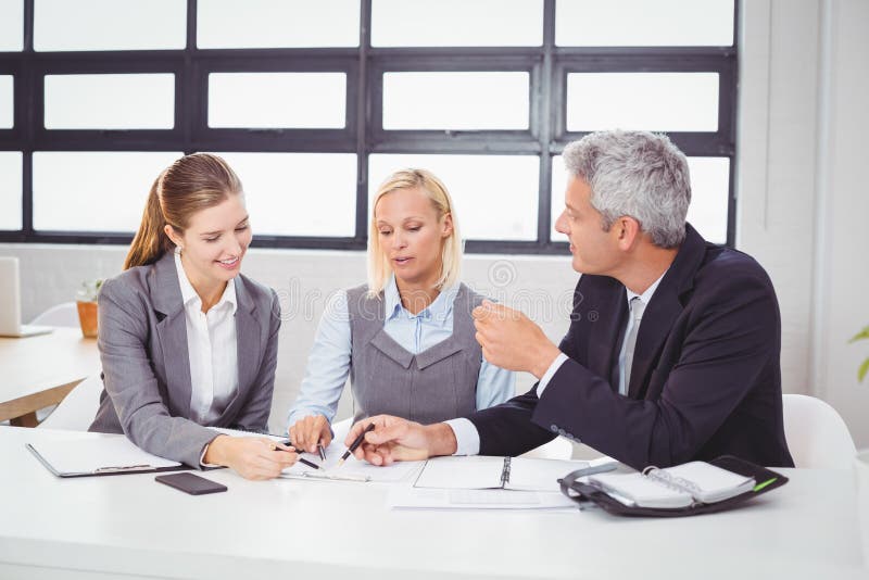 Business People Discussing with Client Over Documents Stock Photo ...