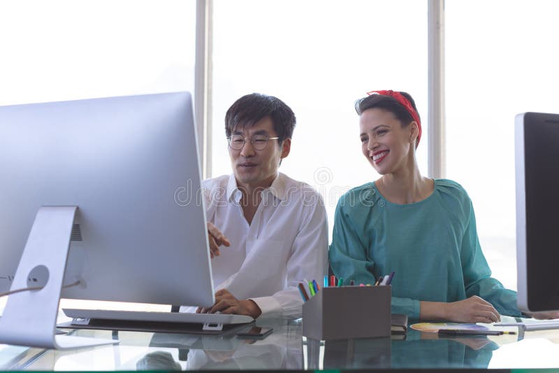 Business People Discussing Over Computer at Desk in Office Stock Image ...