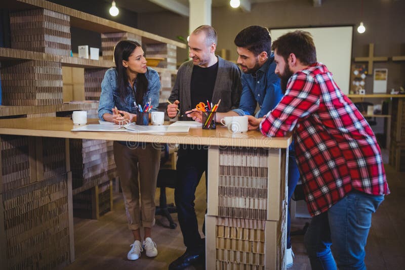 Business People Discussing Over Documents at Table Stock Image - Image ...