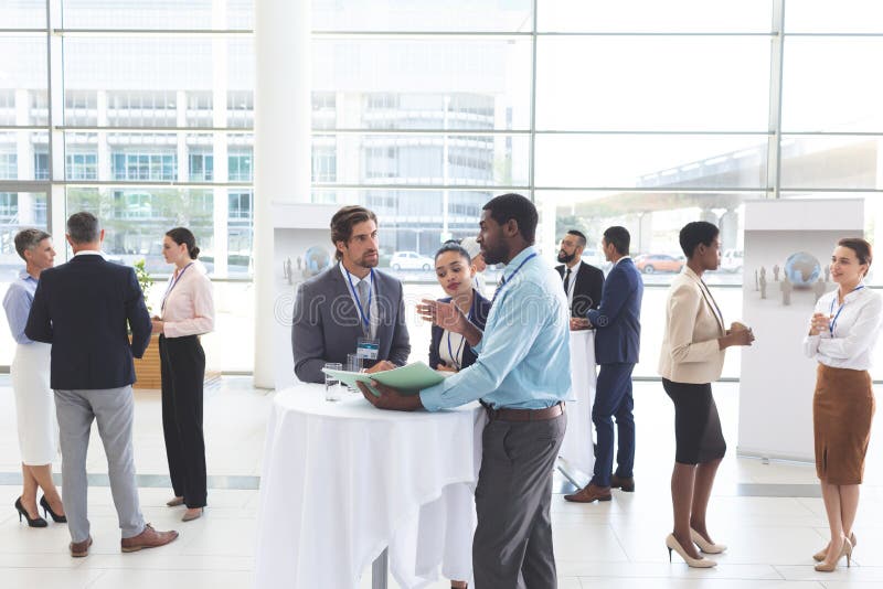 Business People Discussing Over Documents at Table during a Seminar ...