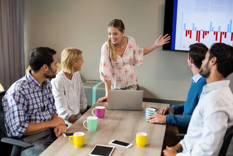 Business People Discussing Over Graph during a Meeting Stock Image ...