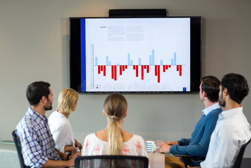 Business People Discussing Over Graph during a Meeting Stock Photo ...