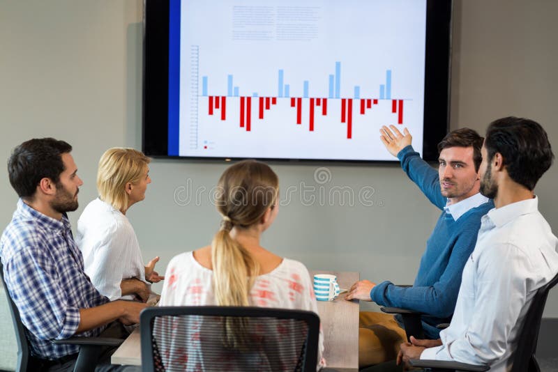Business People Discussing Over Graph during a Meeting Stock Image ...