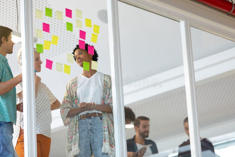 Business People Discussing Over Sticky Notes in the Office Stock Photo ...