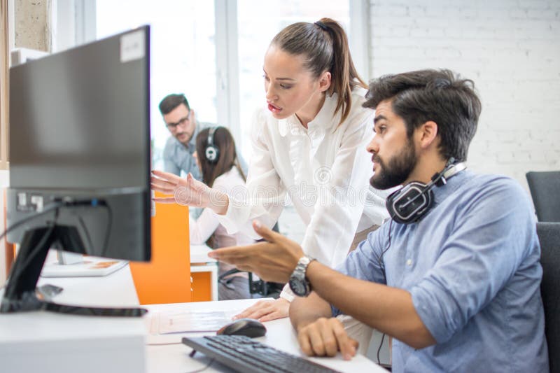 Business People Discussing Project on Desktop Computer Together in ...