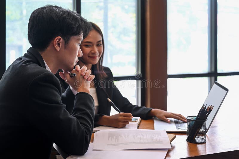 Businesspeople Discussing Their New Project Together in Office. Stock ...