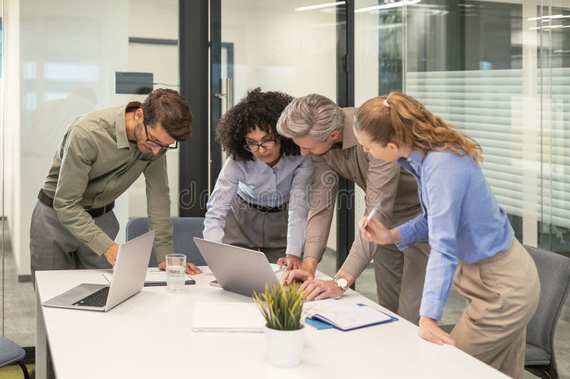 Business People Discussing Work Together Using a Tablet and Laptop ...