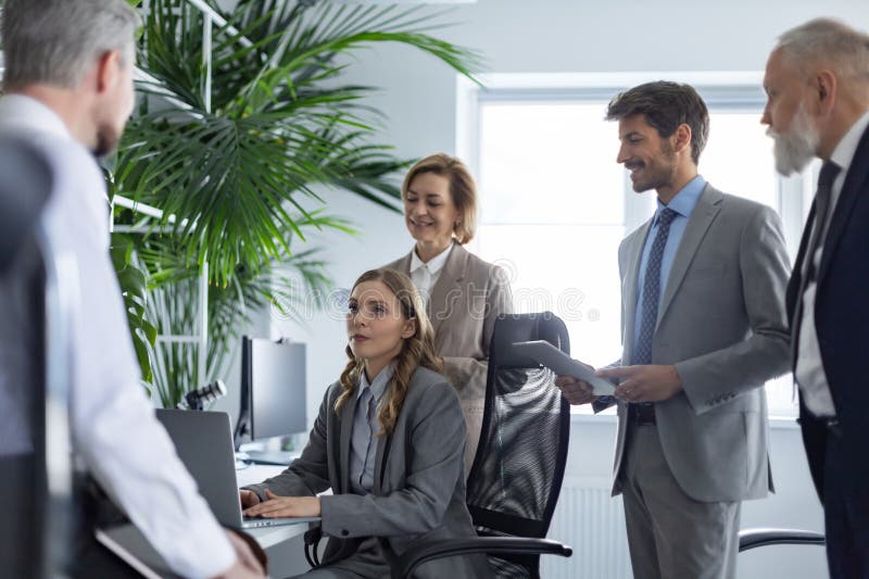Business People Discussing Work Together Using a Tablet and Laptop ...
