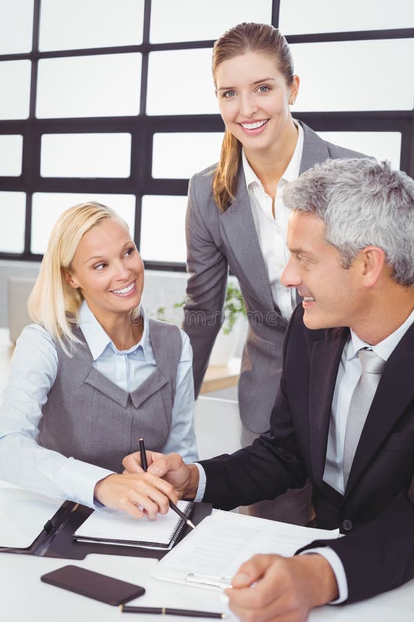 Business People with Documents at Desk Stock Image - Image of coworkers ...