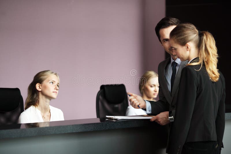 Business People at Front Desk Stock Photo - Image of professional ...