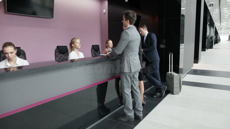Front Desk Team Staff Welcoming Hotel Guest at Reception Stock Video ...